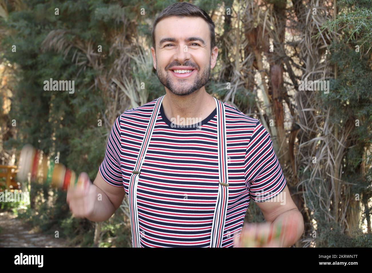 Cute male juggler practicing outdoors Stock Photo - Alamy