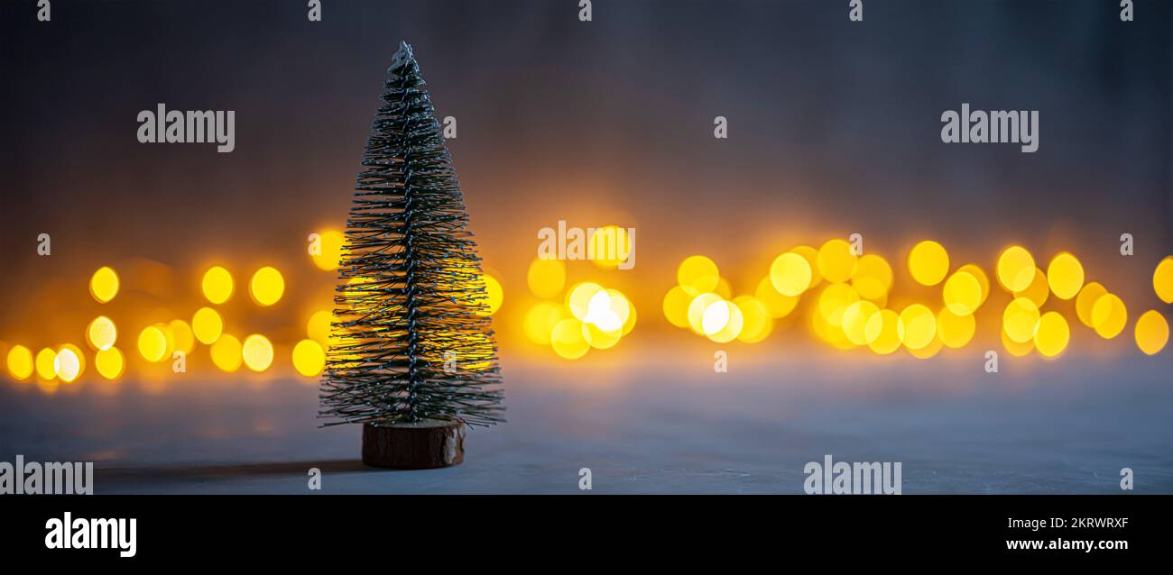 Shallow depth of field image of small Christmas tree on table with ...