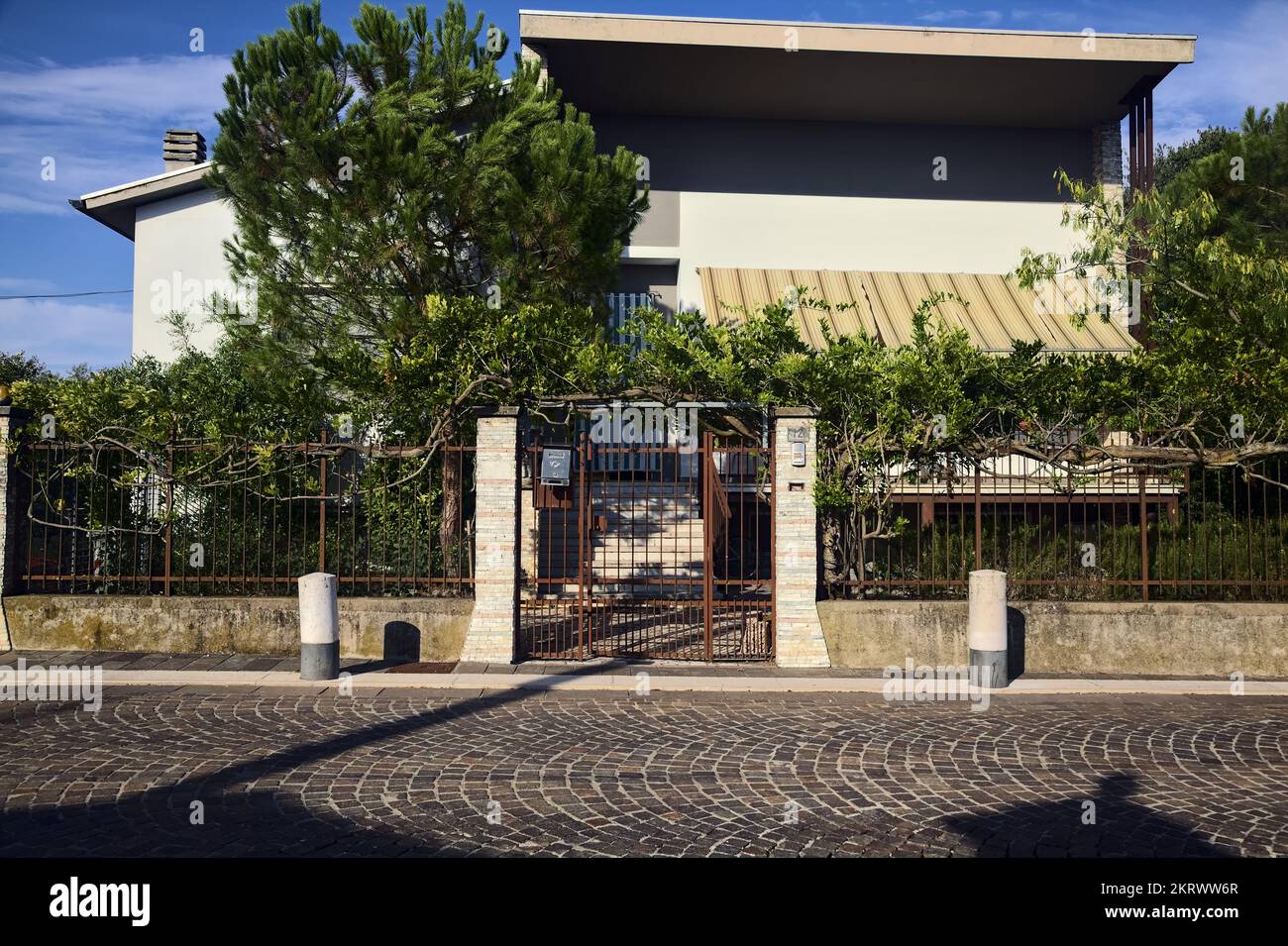 Gate and door with plants surrounding them and the facade Stock Photo ...