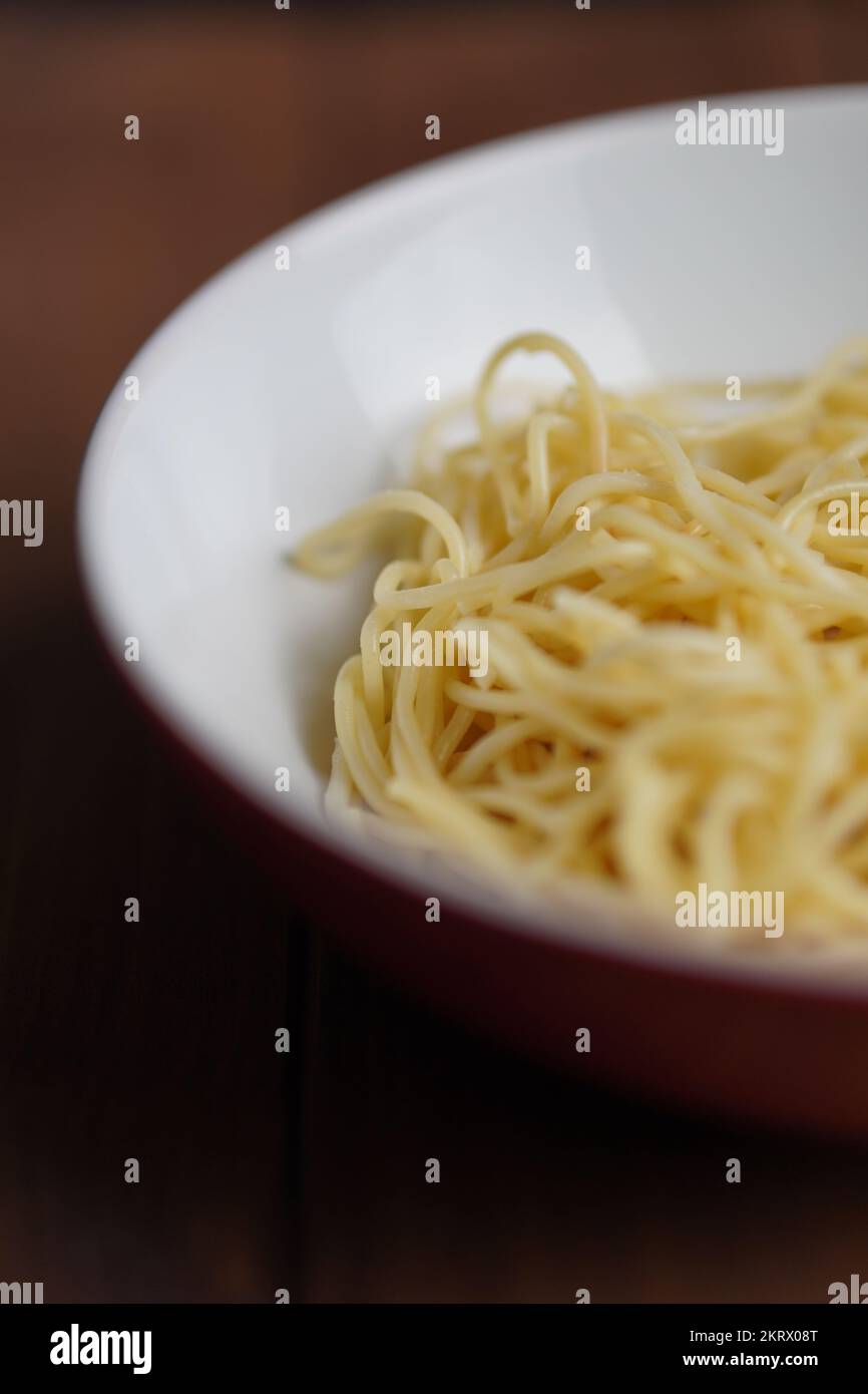 Classic pasta on white plate on wood background with fork ans spoon ...
