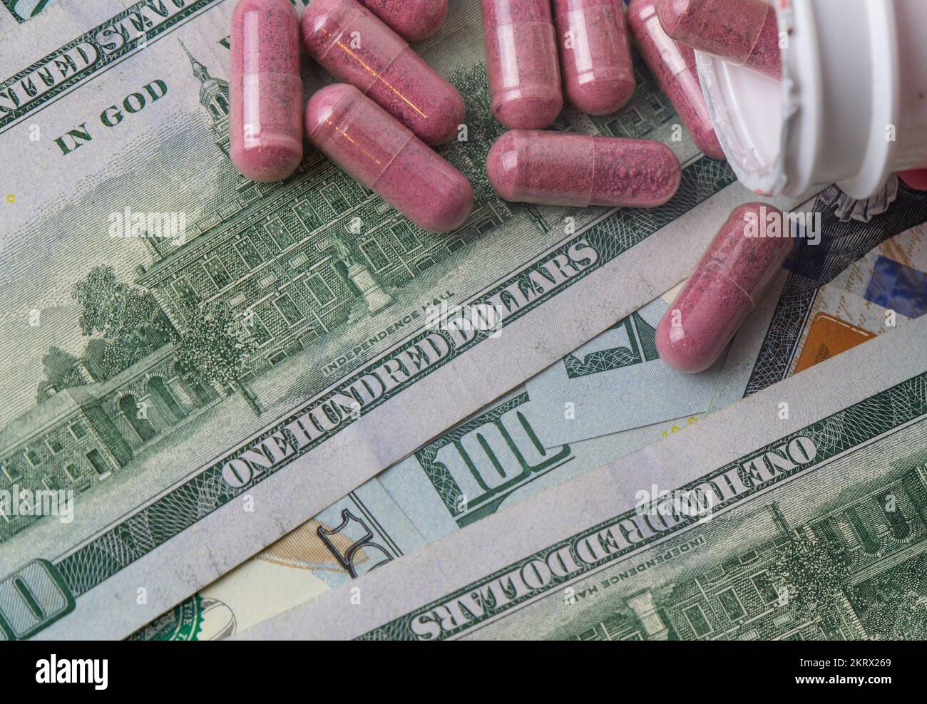 red pills on background of cash money, drug industry concept Stock ...