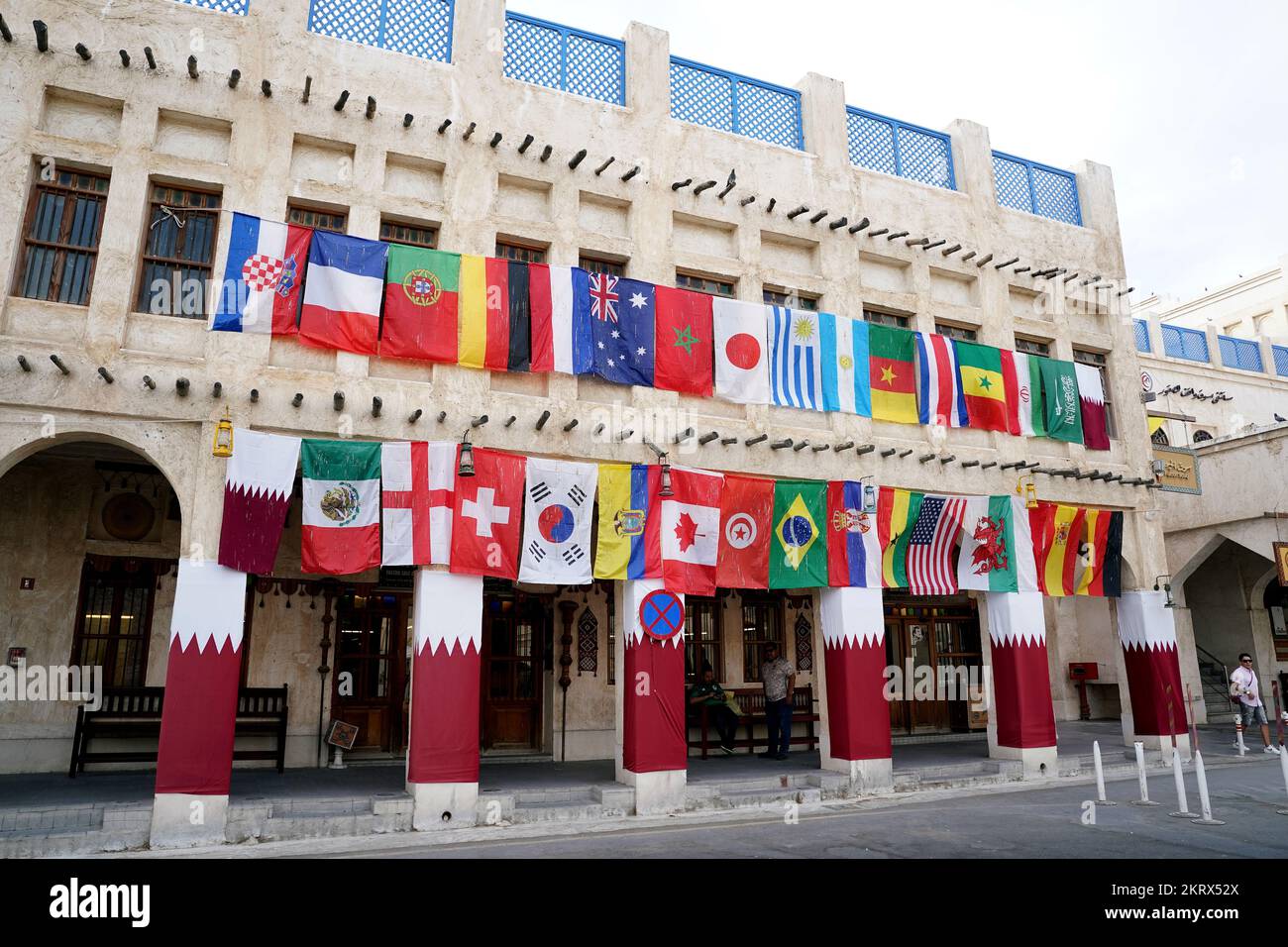 Flags of the competing World Cup nations adorn a building in Doha ...