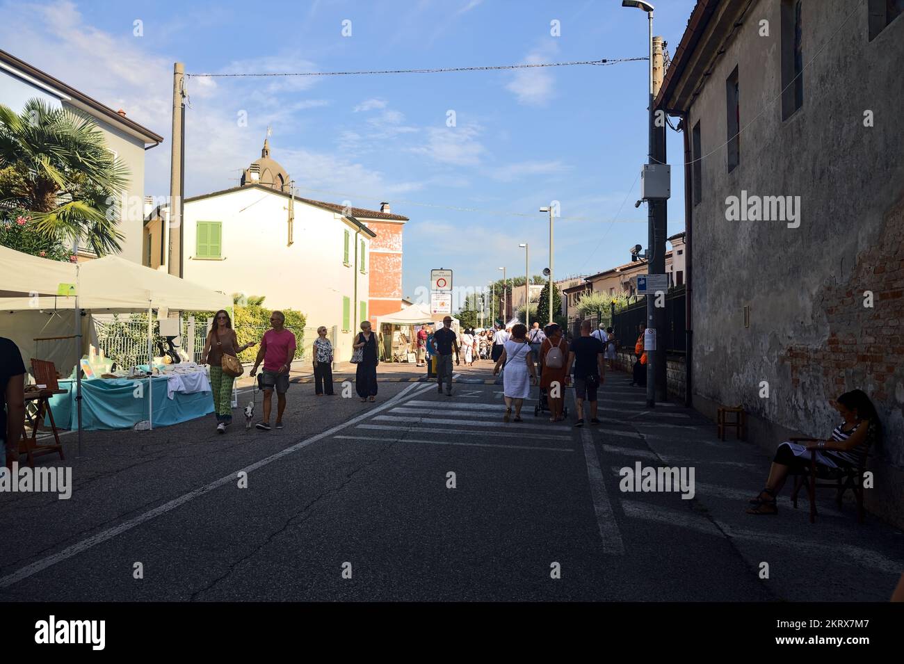 Stalls and crowd of a fair in the italian countryside in summer Stock ...