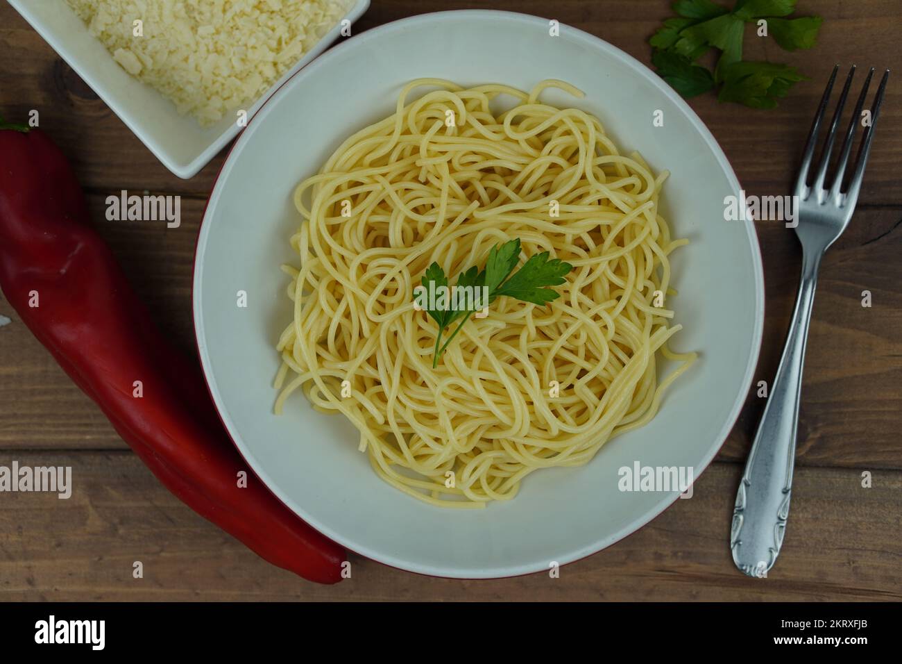 Classic pasta on white plate on wood background with fork ans spoon ...