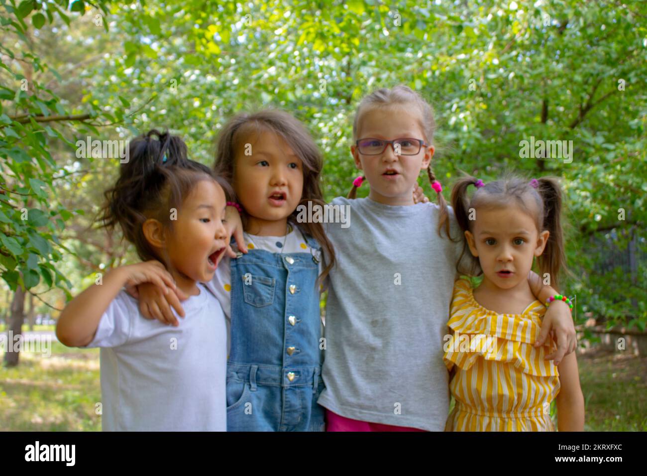 Smiling group of children in the park, talking each other Stock Photo ...