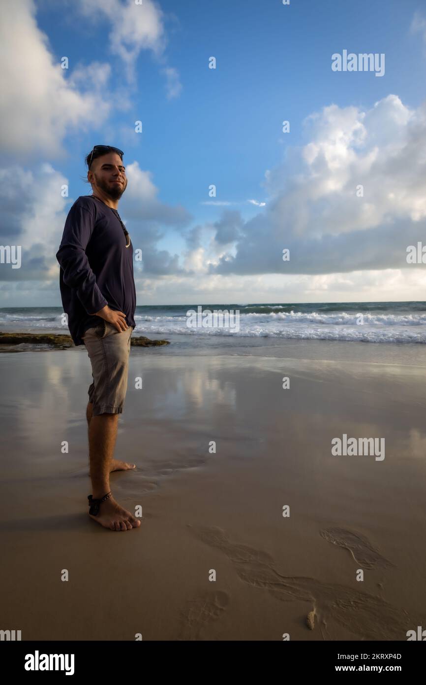 Hipster man with hands on waist at the beach. laid back attitude Stock ...