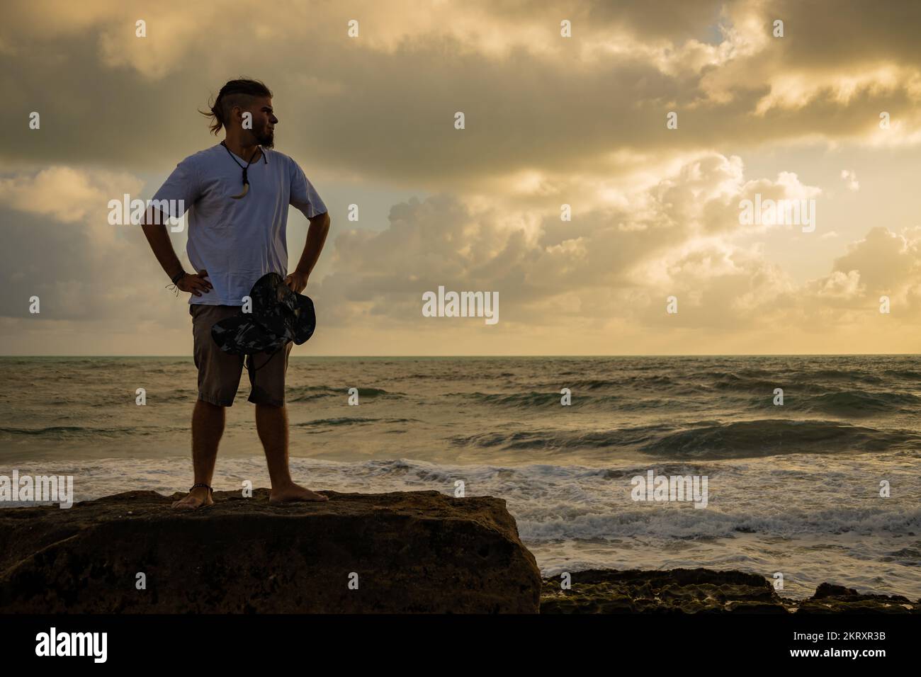 Hipster man with hands on waist at the beach. laid back attitude Stock ...