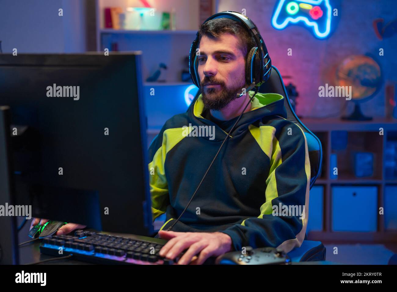 Gamer focusing on online video games championship, playing action game ...