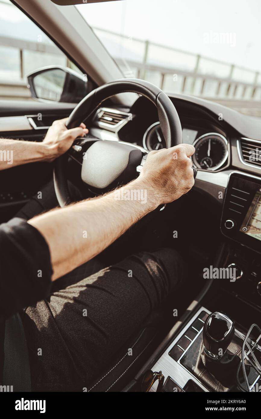 Close up shot of male hands on a car's steering wheel Stock Photo - Alamy