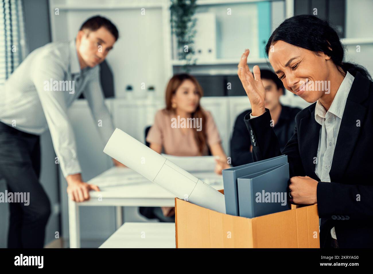 An emotional image of a fired employee packing up her possessions for ...