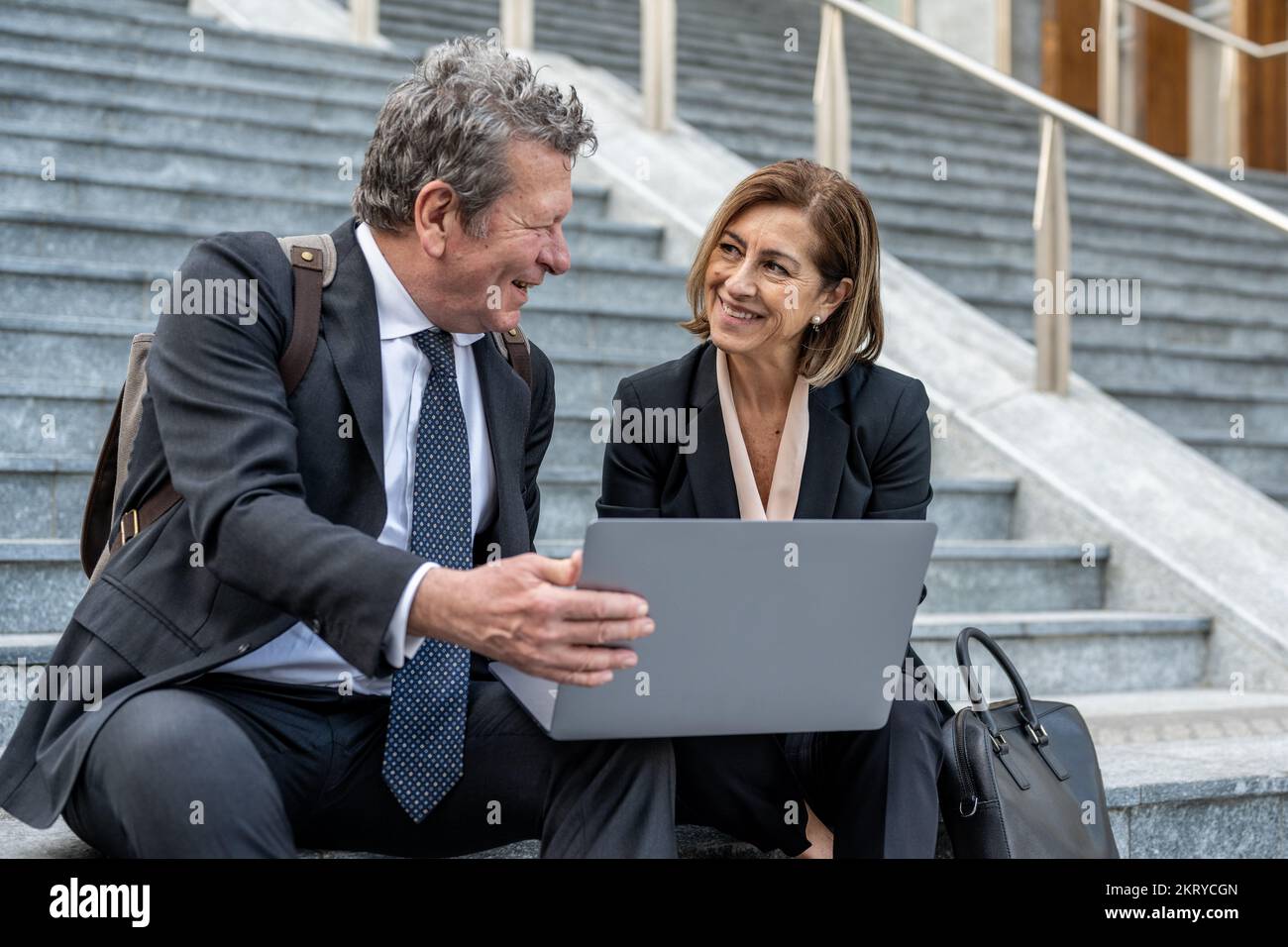 Two business people talking about project strategy outside, businessman ...