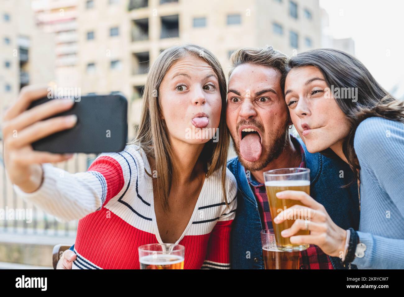 group selfie of generation z people, making funny facial expression ...