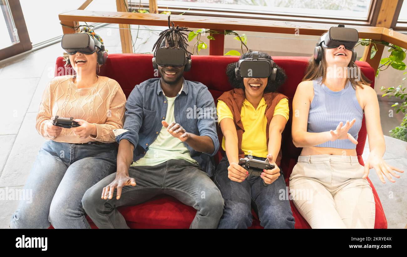 Team of young gamers palying videogames wearing brand new headsets for ...