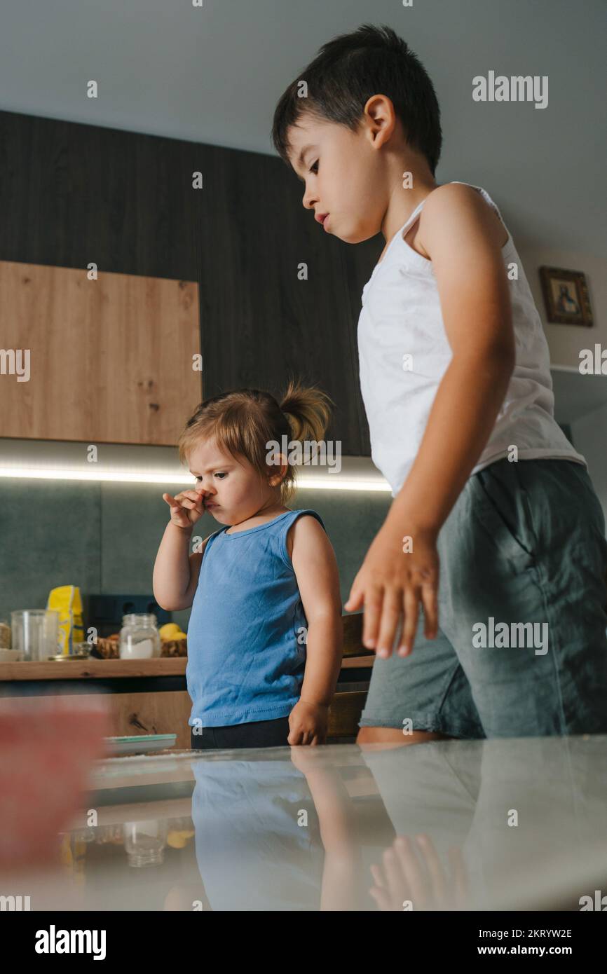 Brother with his little baby sister baking homemade sweet cookies ...