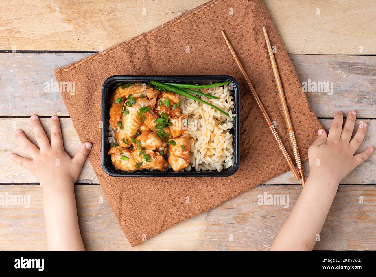 Kids hands holding lunch box with food sticks Stock Photo - Alamy