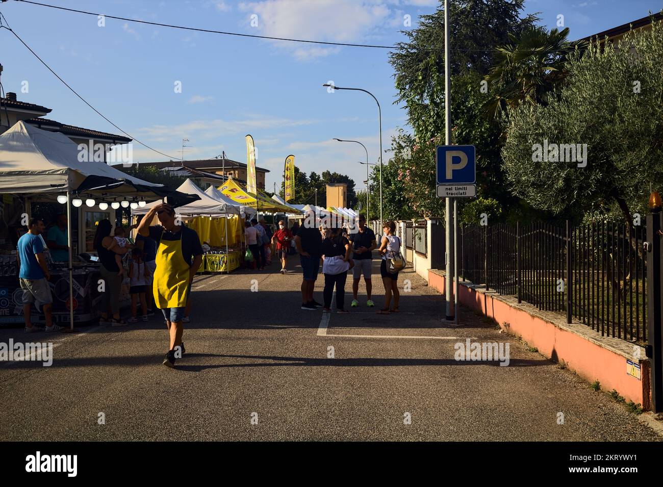 Stalls and crowd of a fair in the italian countryside in summer Stock ...