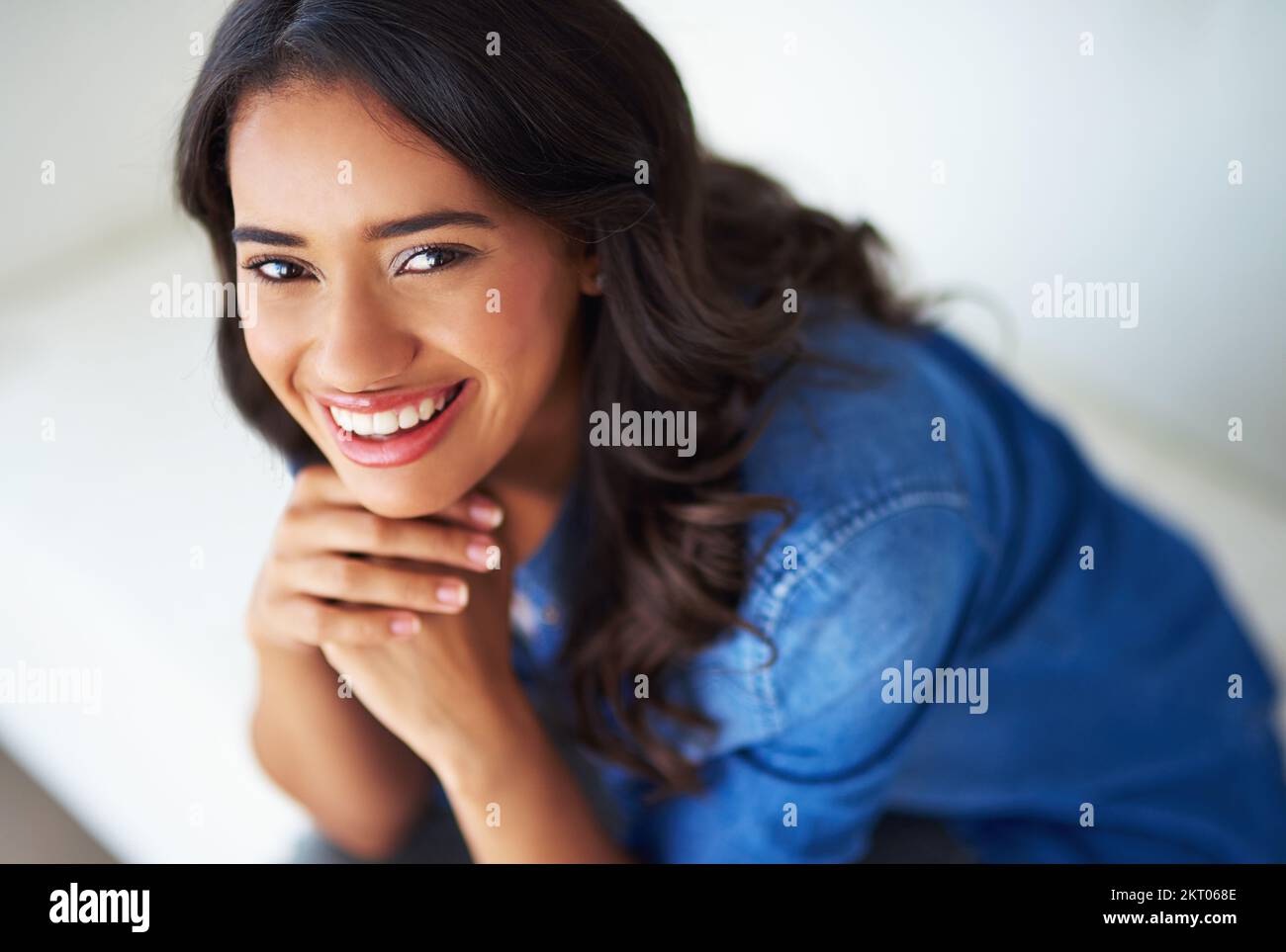 Portrait, face and happy with a black woman in her home to relax alone ...