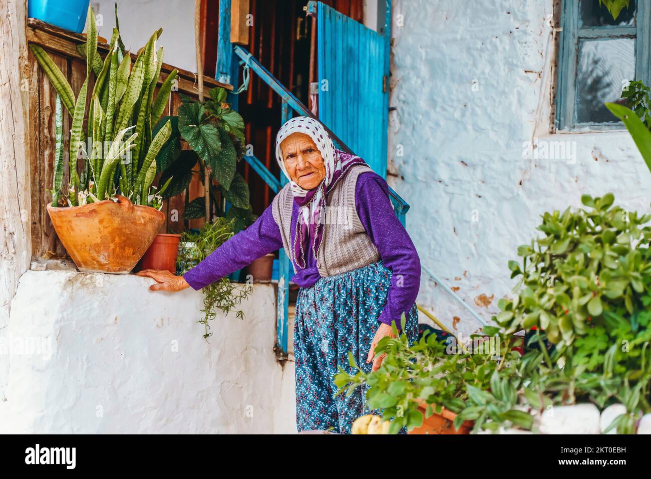 Kash, Turkey - November 28, 2022: Turkish old woman near her house with ...