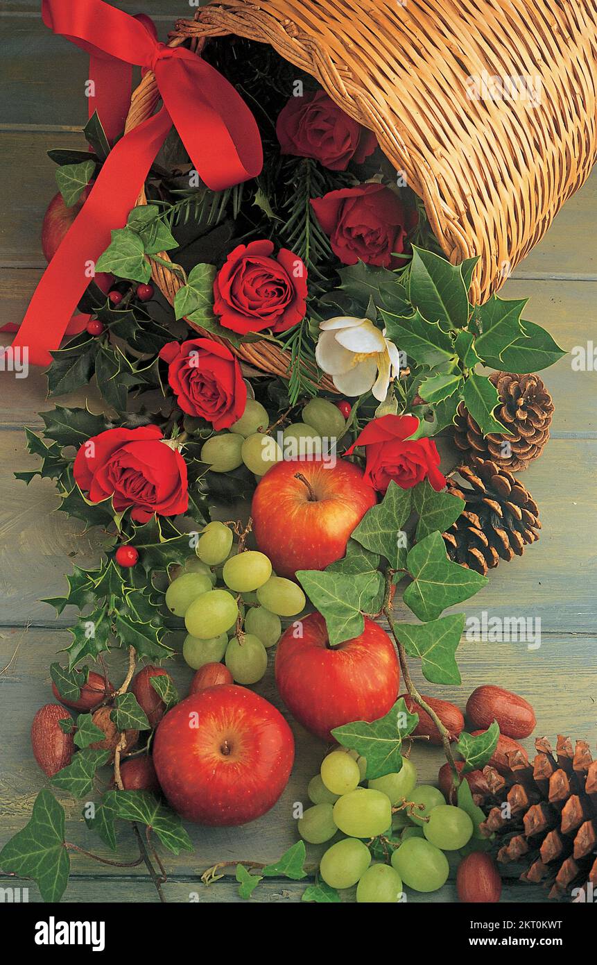 Greek basket with a cascade of fruit and roses Stock Photo - Alamy