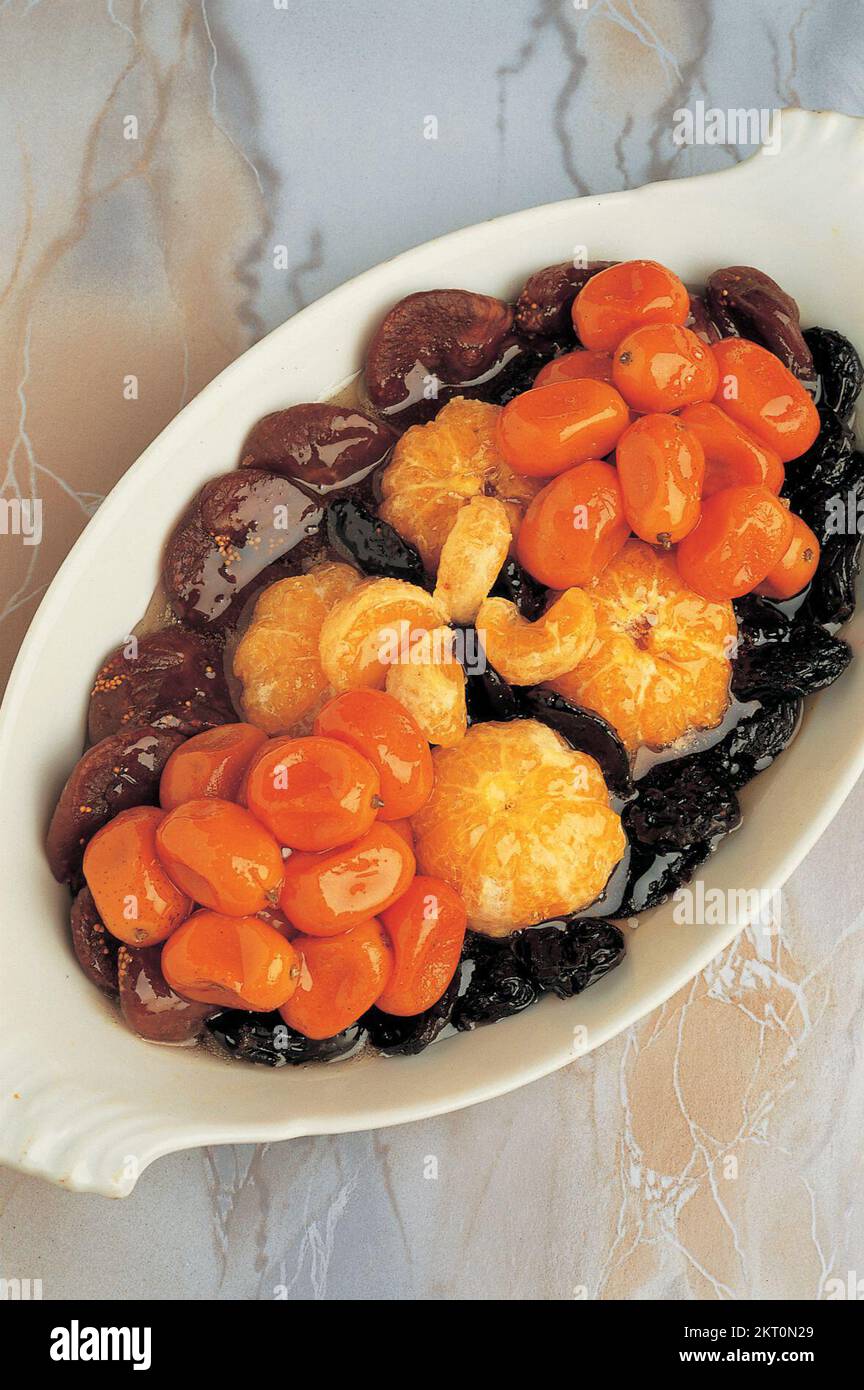 Fruit soaking in syrup in a dish Stock Photo - Alamy