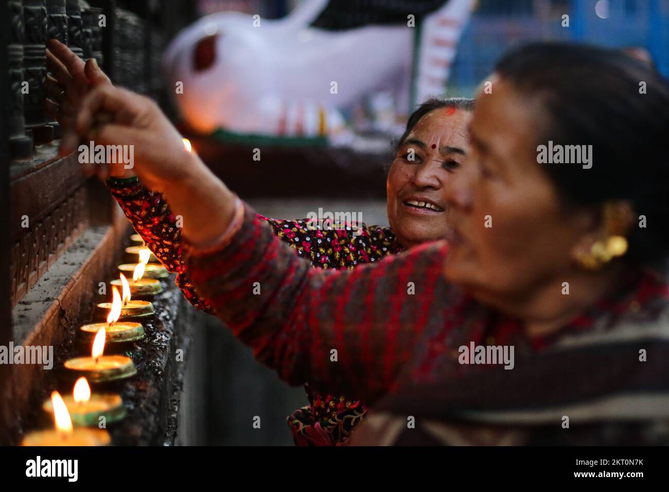 Nepal. 29th Nov, 2022. Women rotate prayer wheel at Macchindra Bahal ...