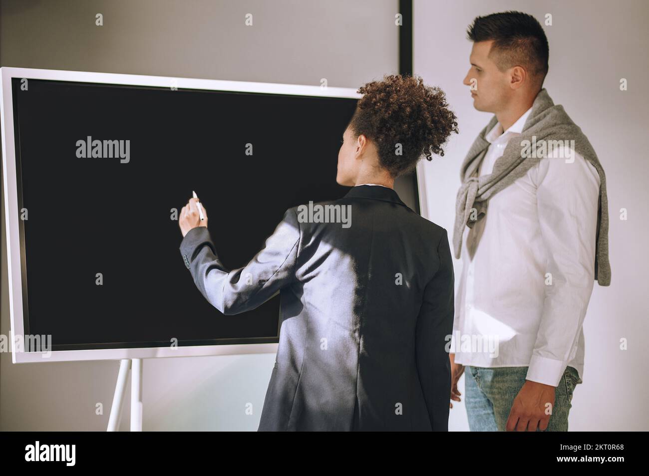 Woman writing on back board hi-res stock photography and images - Alamy