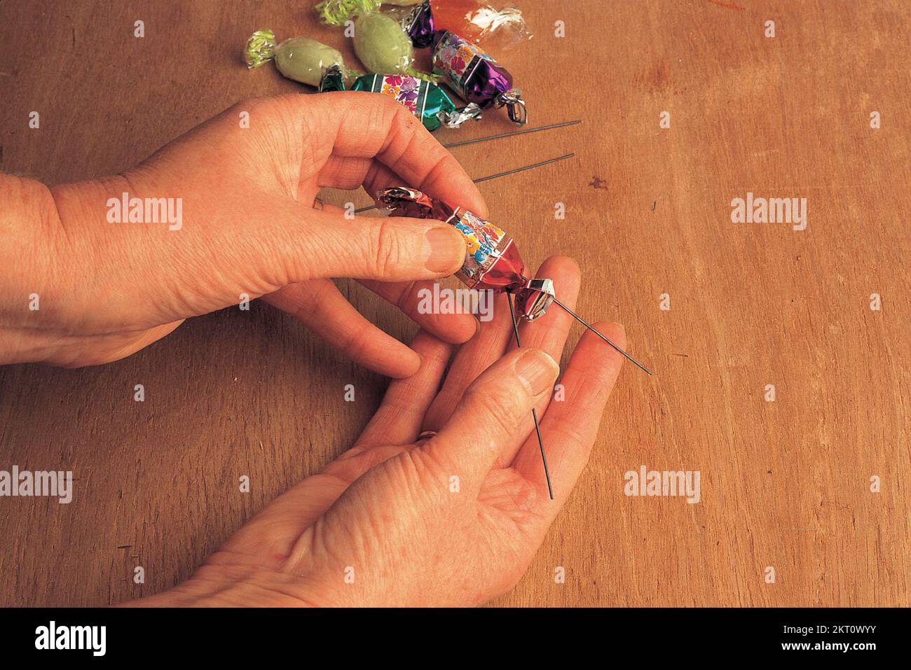 Twisting the ends of the wire around candy Stock Photo - Alamy