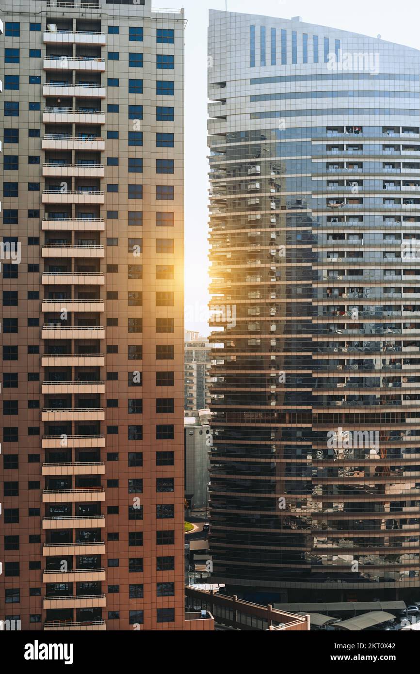A vertical shot of two modern residential skyscrapers with patterns of ...