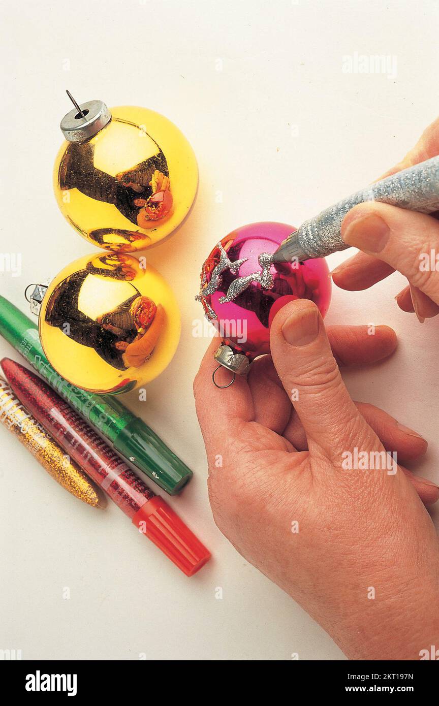 Decorating a bauble with glitter Stock Photo - Alamy