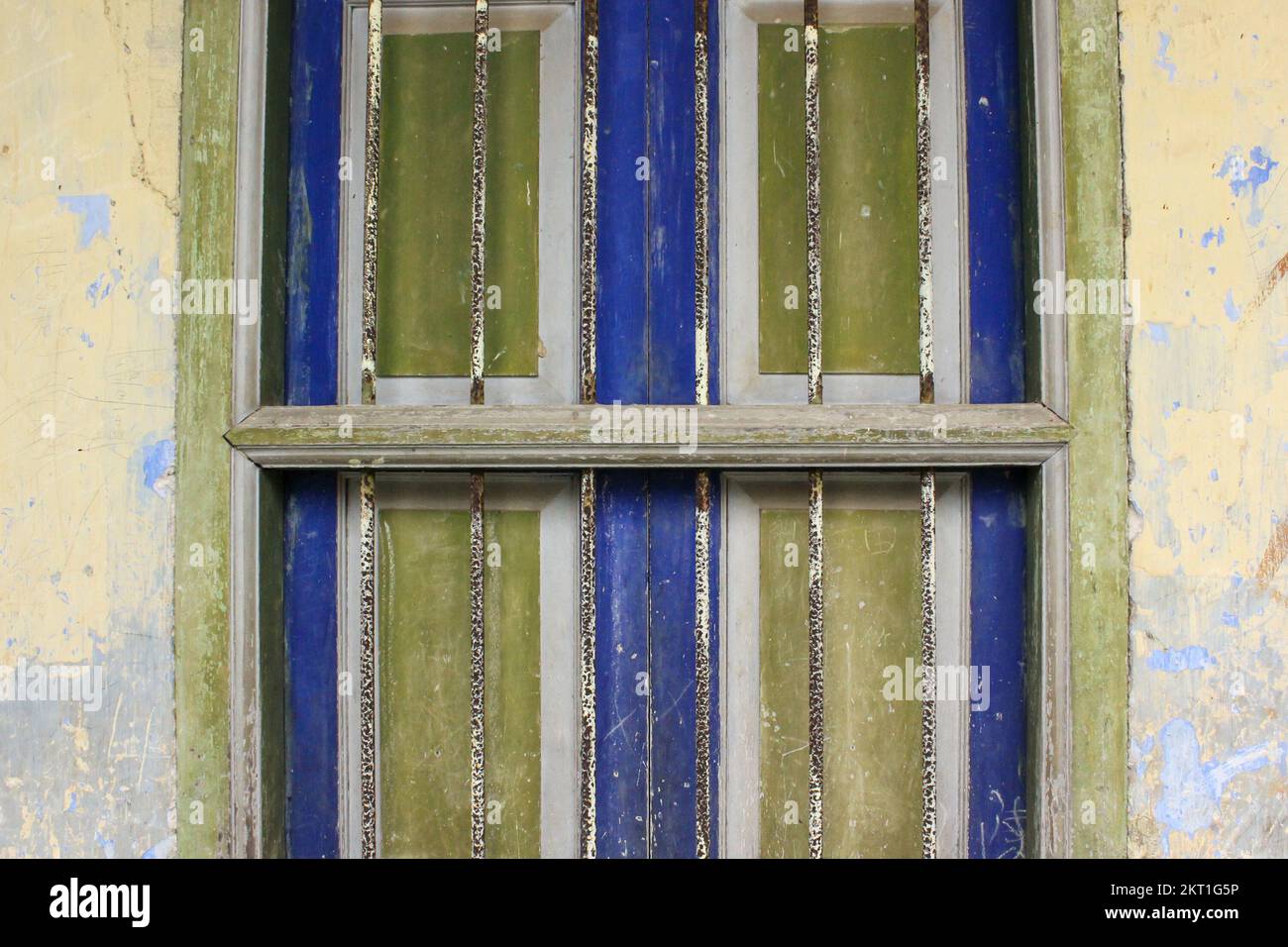 A colorful vintage window with metal grills of an old house in the town ...