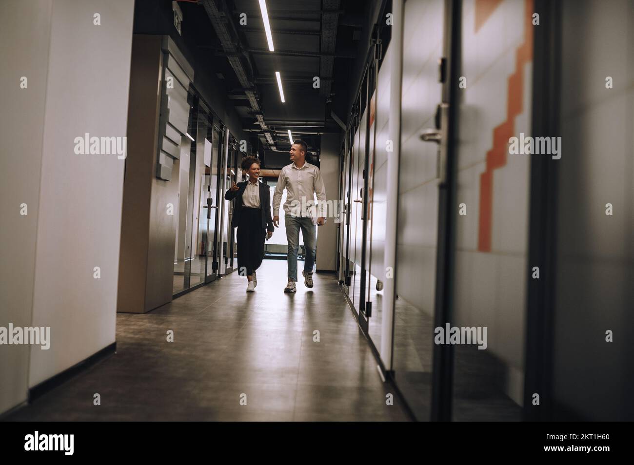 Woman walking down corridor hi-res stock photography and images - Alamy