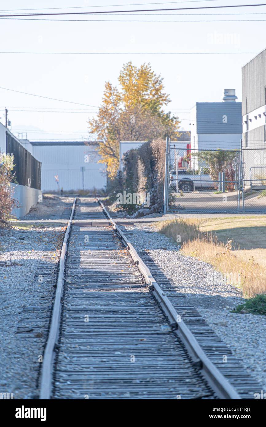 Railway track in industrial area for shipping Stock Photo - Alamy