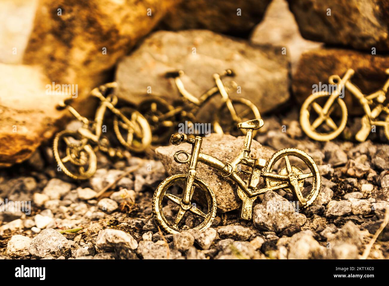 Bike riders scene with a group of bronze cycle charms on mountainous ...