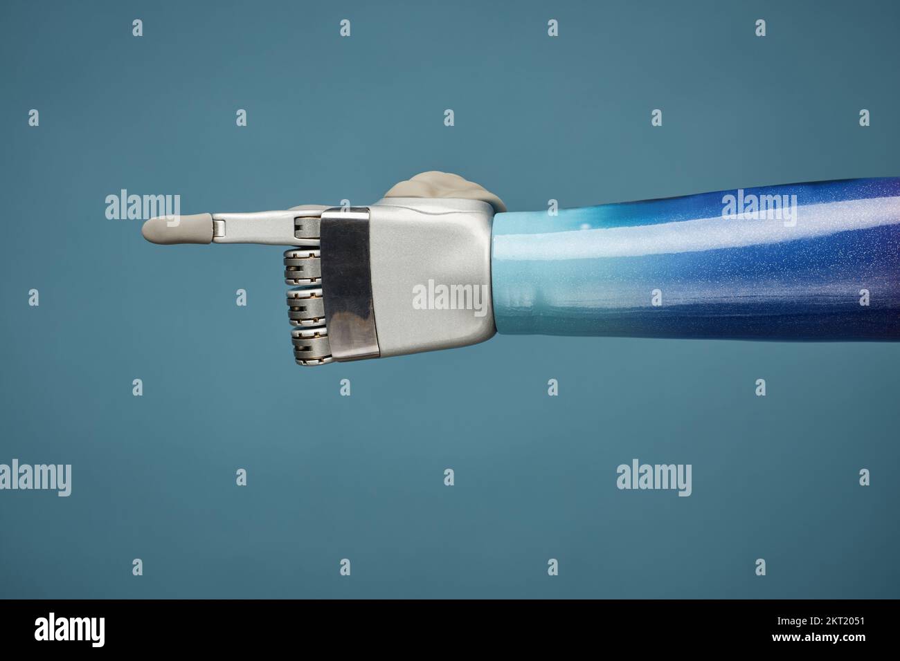 Prosthetic arm pointing with index finger, isolated on blue Stock Photo ...
