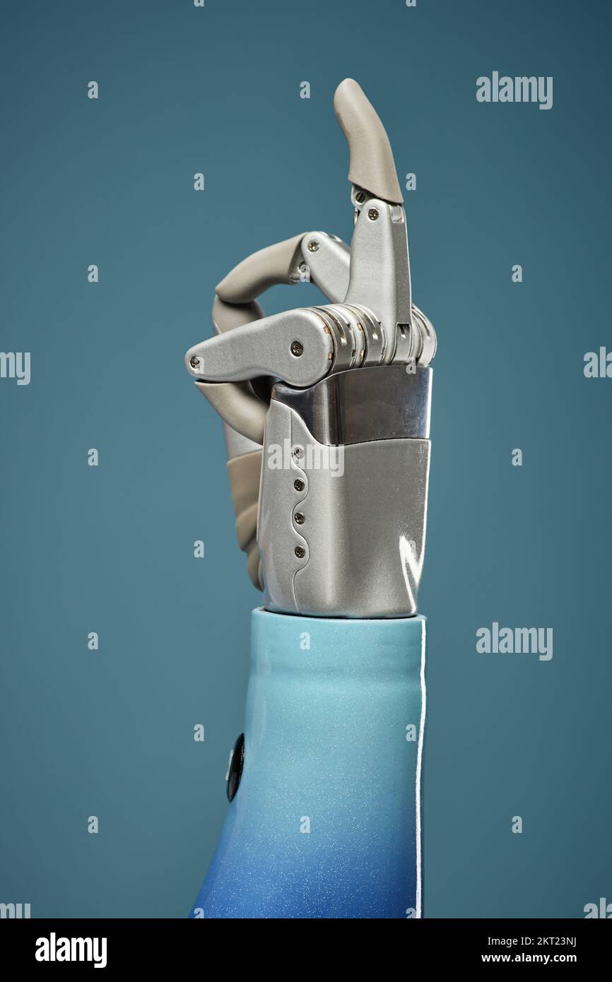 Prosthetic arm showing middle finger, isolated on blue background Stock ...