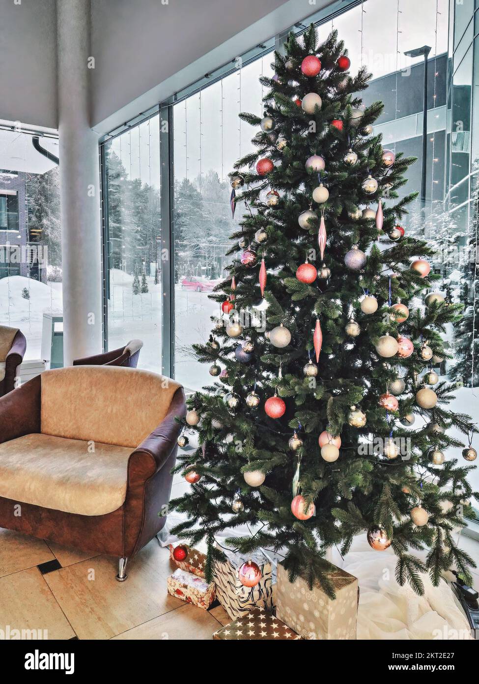 Christmas tree decorated with Christmas balls and garland, with gift ...