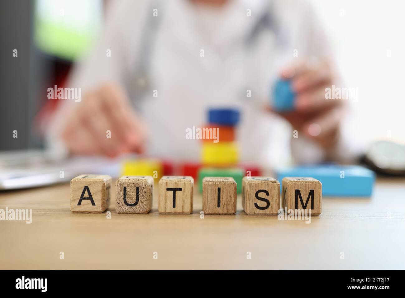 Word autism assembled from wooden blocks close-up and psychiatrist ...