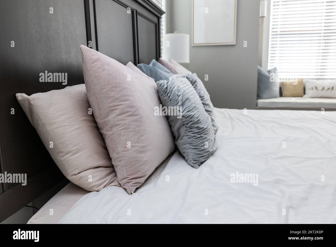 A light and bright gray master bedroom with a large king sized ...