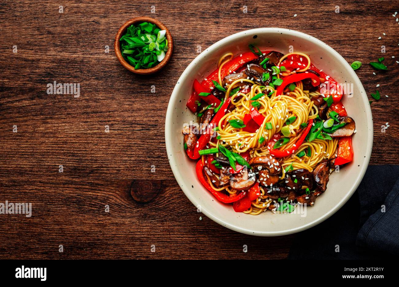 Vegan Stir fry noodles with vegetables, paprika, mushrooms, chives and ...