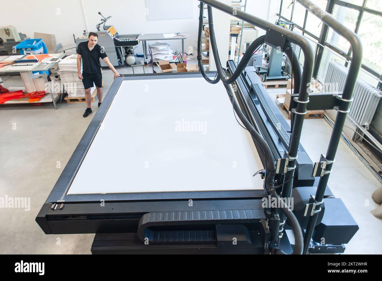 Professional worker printmaker technician operator works in printing ...