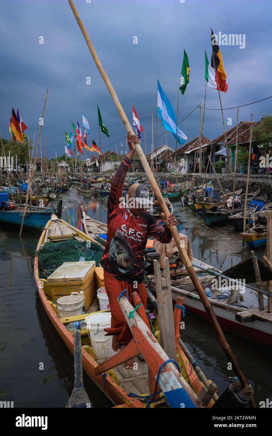 Pasuruan, East Java, Indonesia. 29th Nov, 2022. Fishermen lean their ...