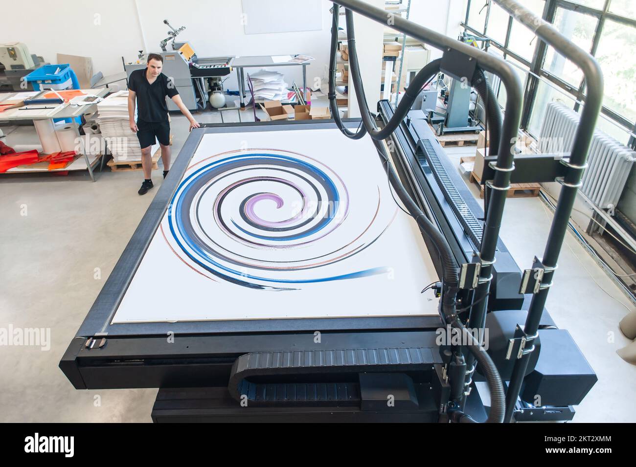 Professional worker printmaker technician operator works in printing ...