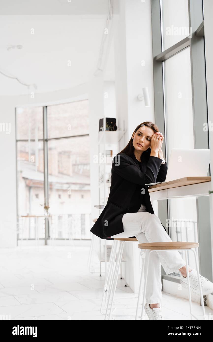 Confident young business woman working online with team on laptop on ...