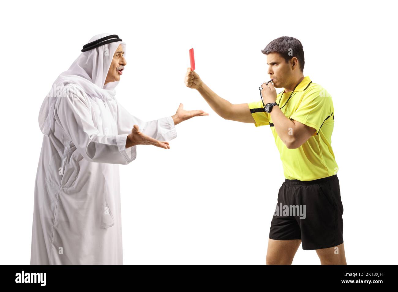 Profile shot of a football referee blowing a whistle and showing a red ...