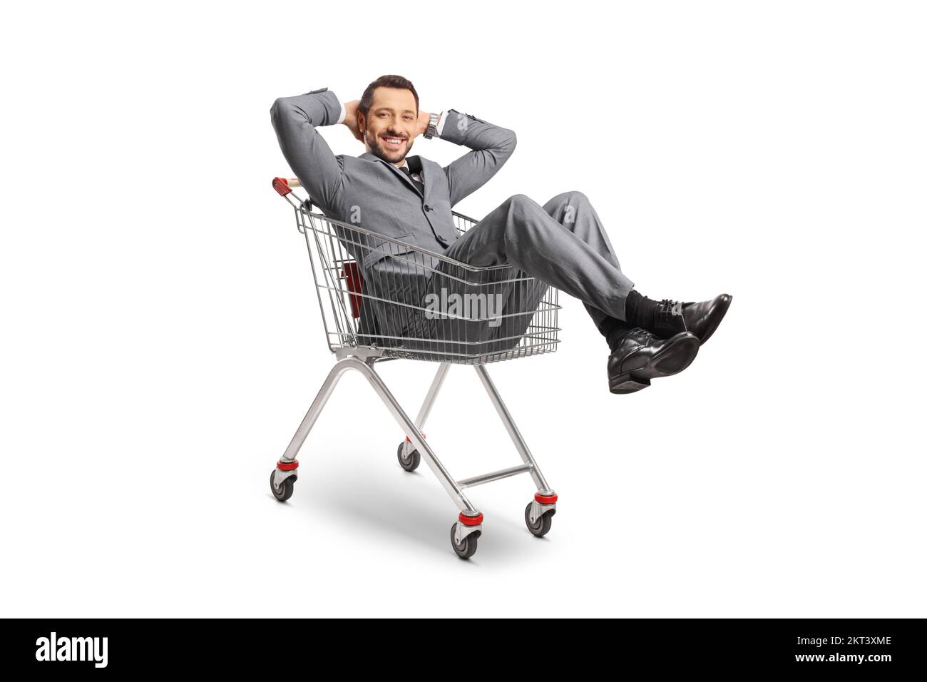 Young professional man sitting inside a shopping cart isolated on white ...