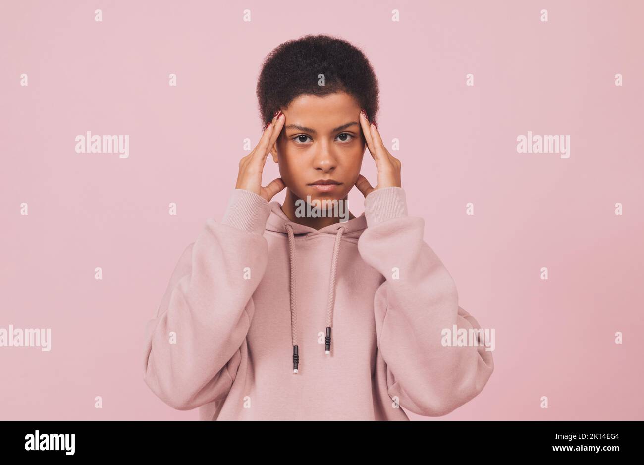 Black stressed out girl touching her head. Close up portrait of young ...