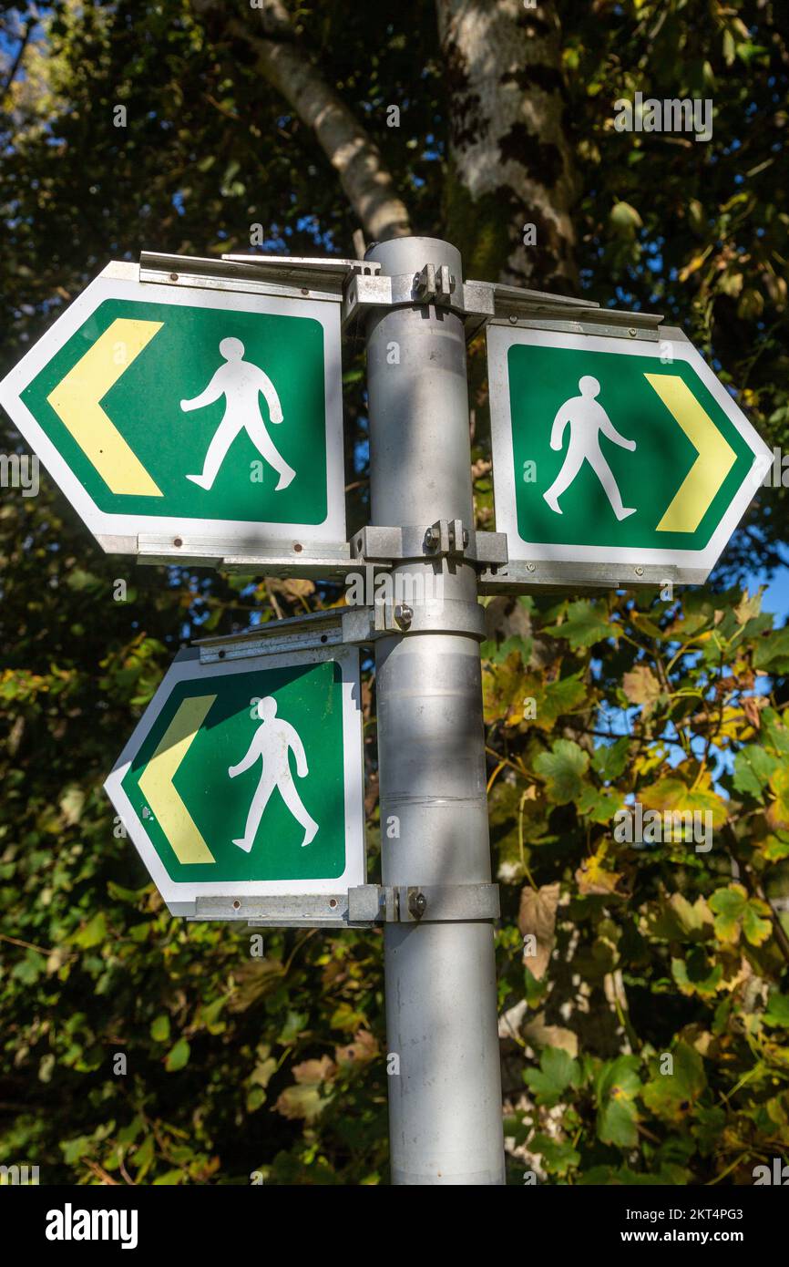 Close up of a metal sign post for walkers pointing in three directions ...