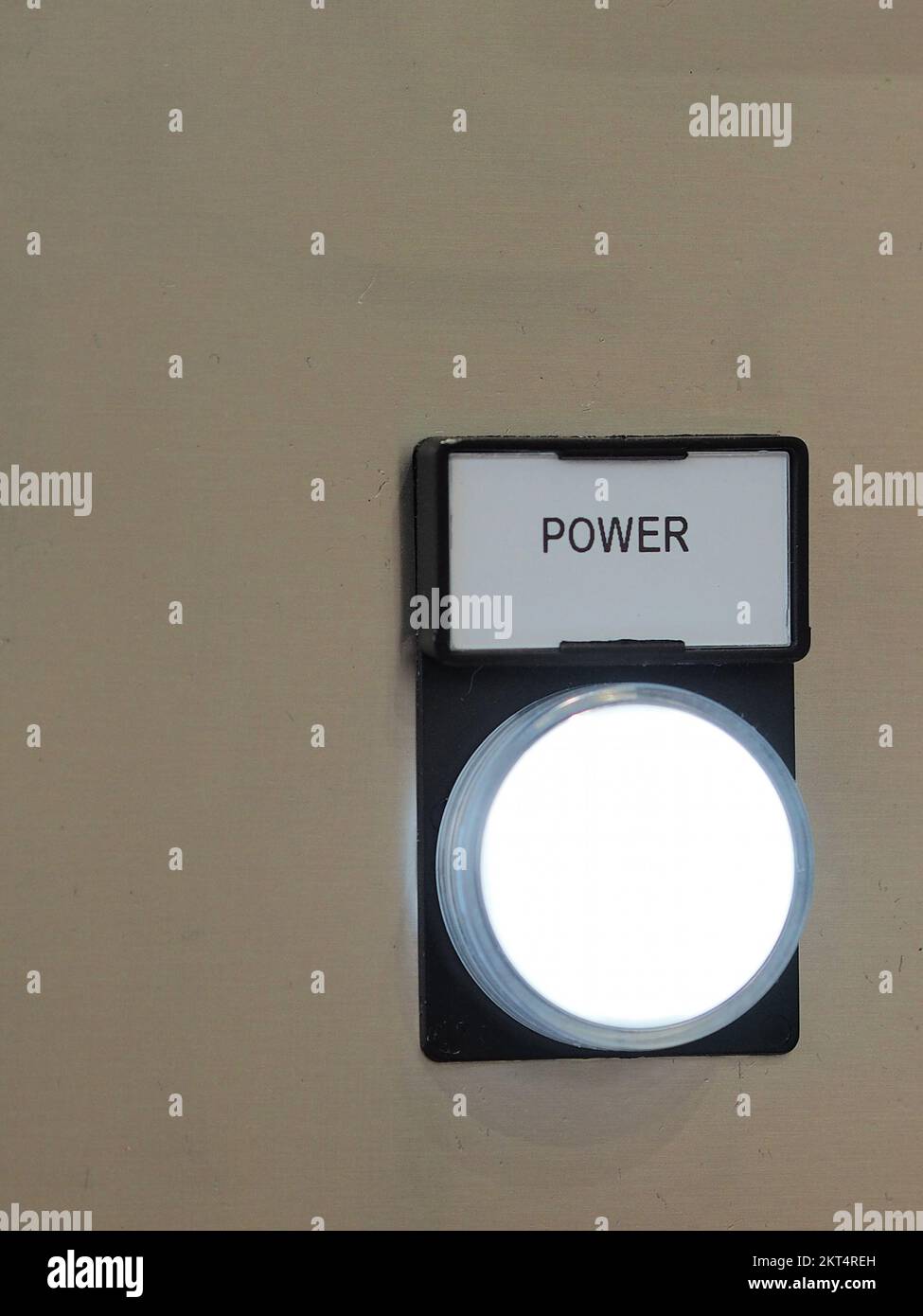 Illuminated and labelled power button on a machine Stock Photo - Alamy