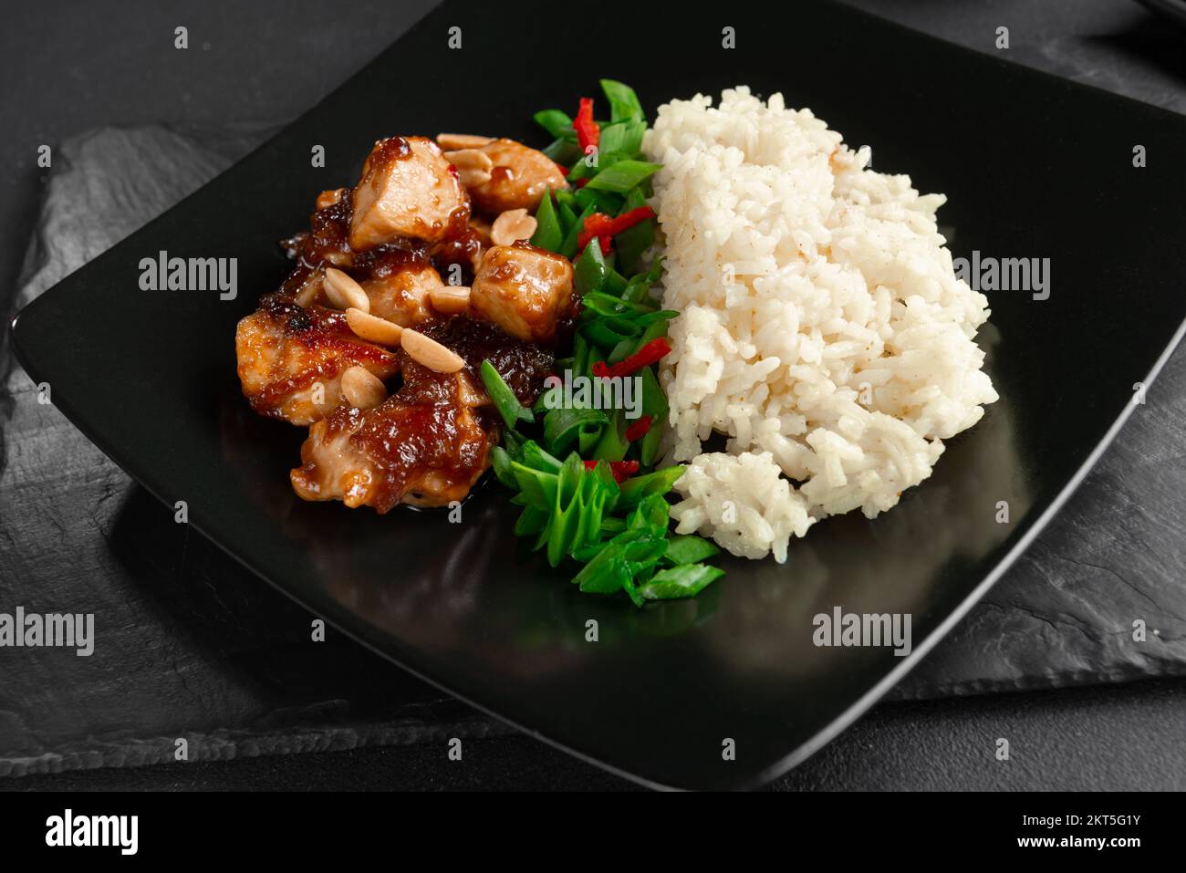 Kung Pao chicken with gravy. Asian food on a black background Stock ...