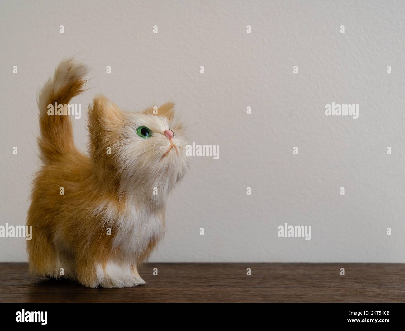 Cute ginger and white teddy kitten or soft toy cat with green eyes ...